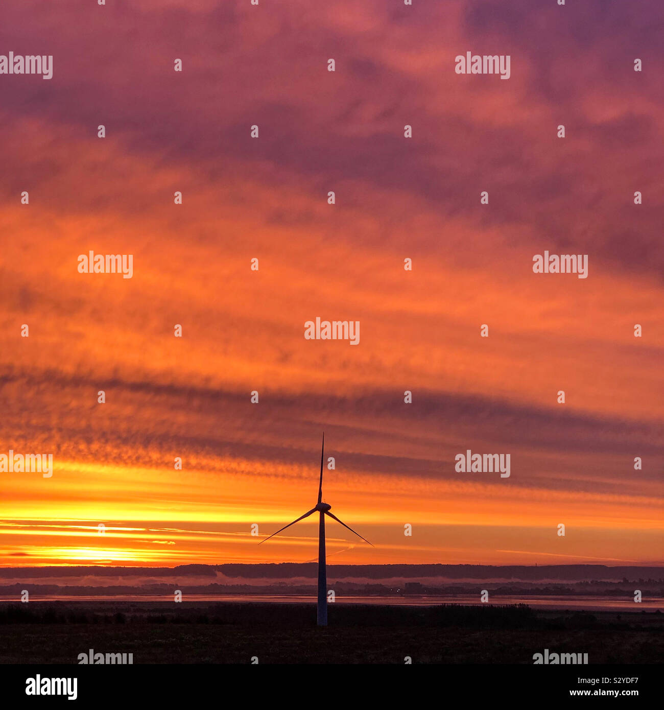 Wind turbine at sunrise Stock Photo - Alamy