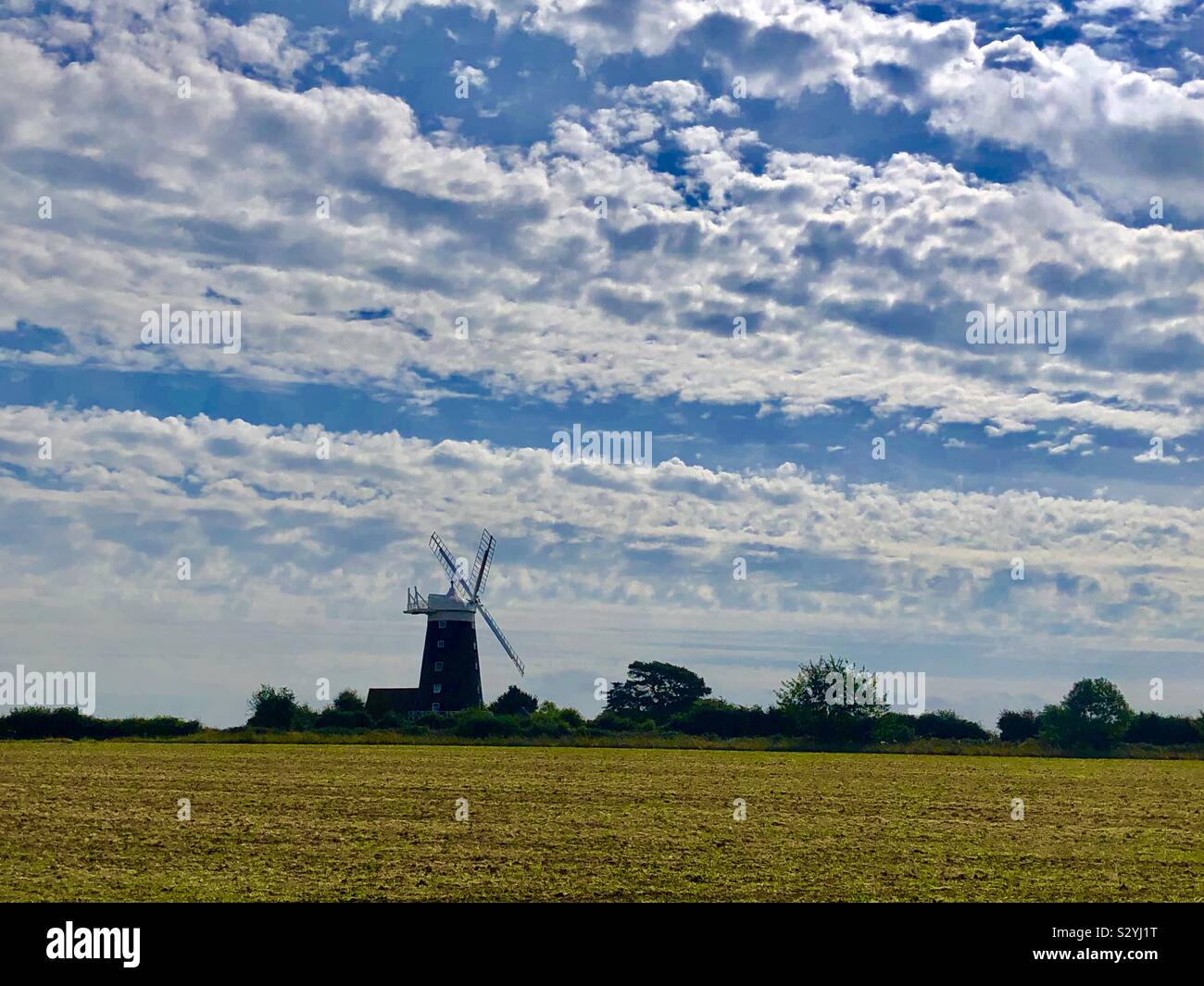 Windmill with clouds Stock Photo - Alamy