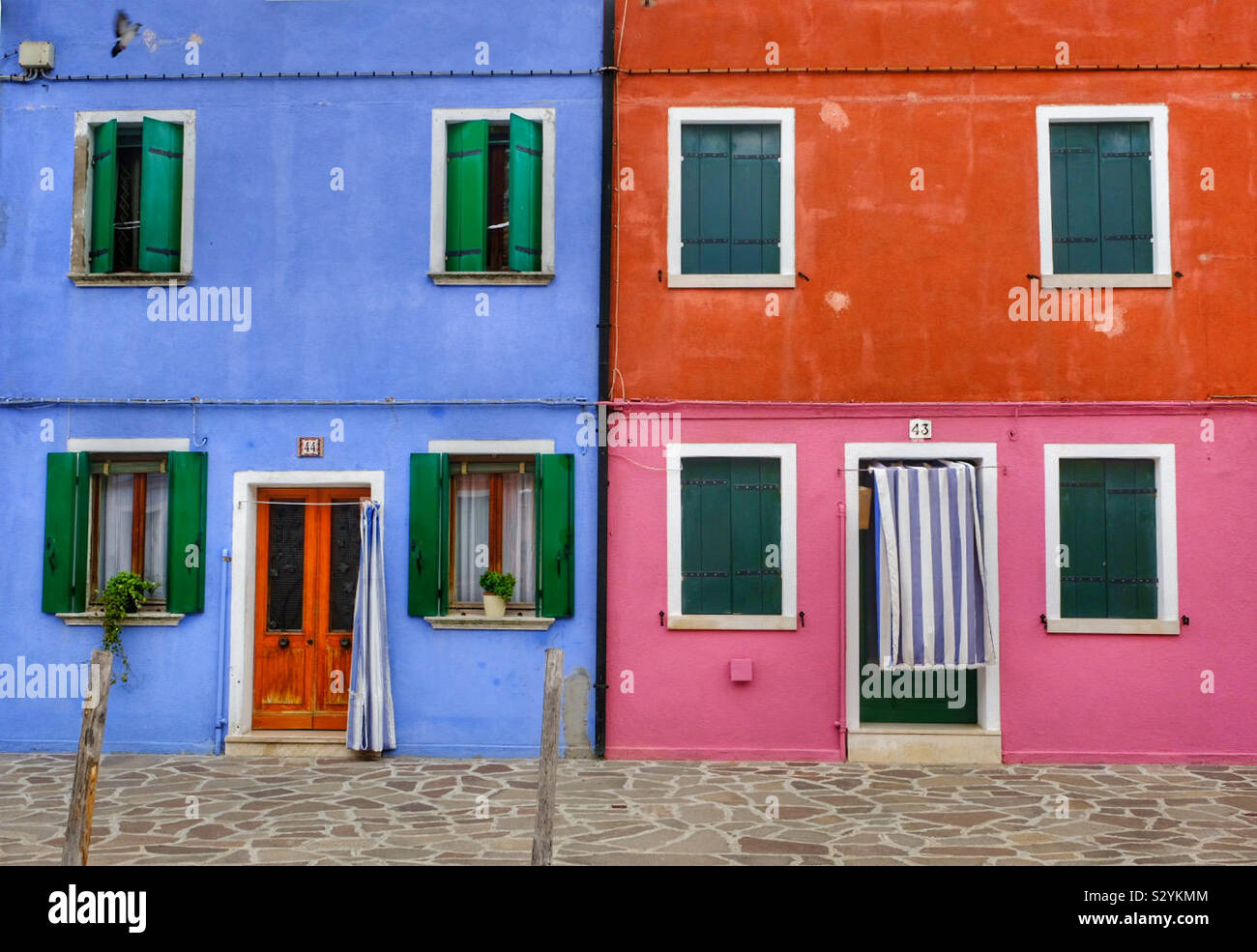 Two brightly coloured house fronts by a canal Stock Photo - Alamy