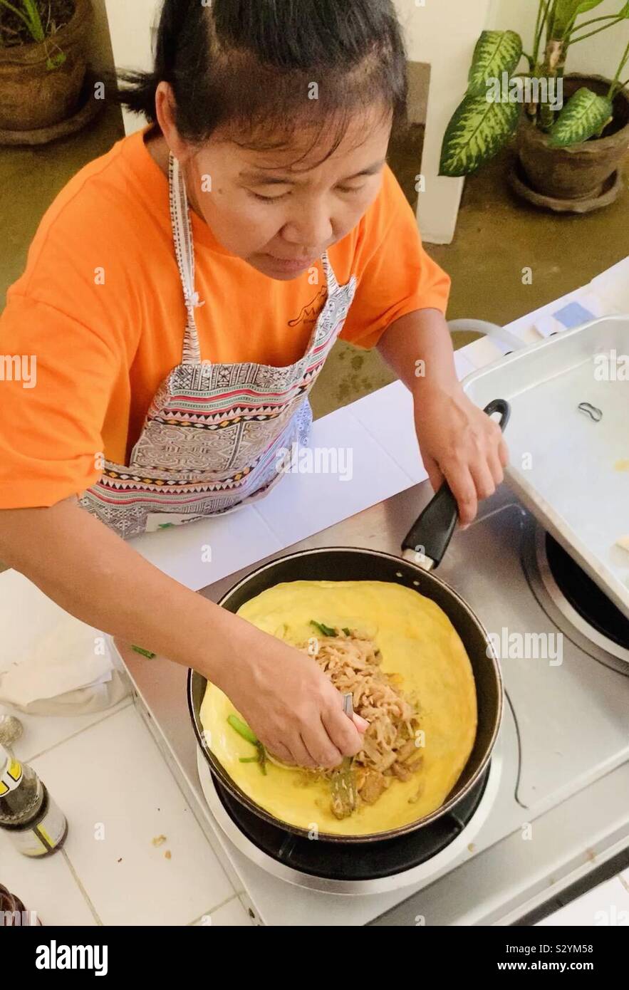 Preparation of egg wrapped Pad Thai Stock Photo - Alamy