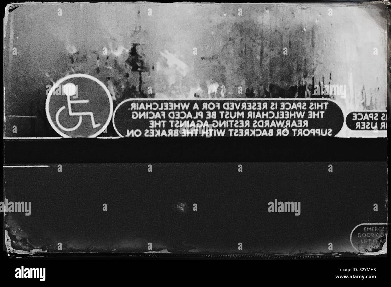 Sign indicating a space for a person in a wheelchair, seen from the ...