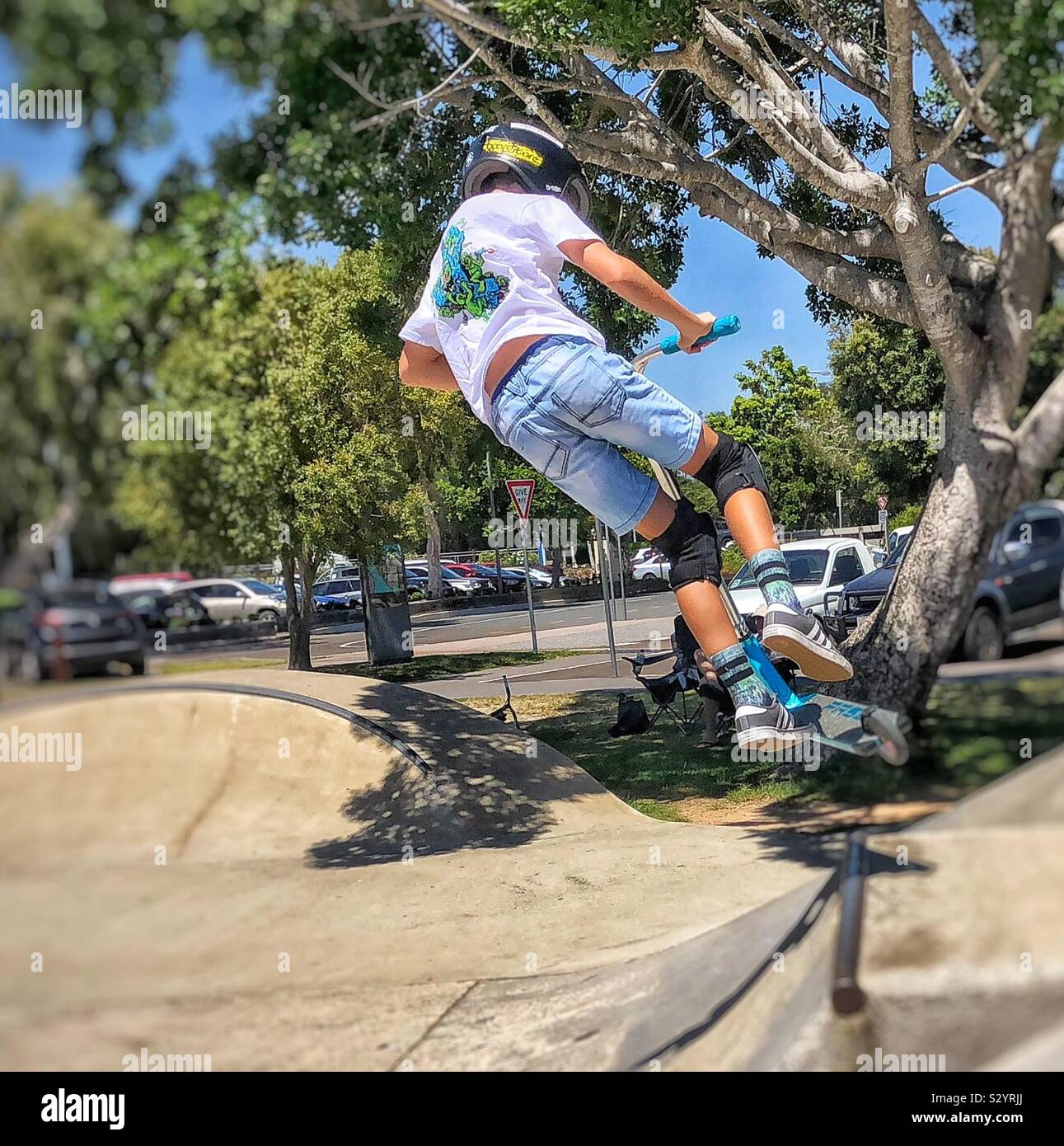 Skateboarding scooter action skatepark Stock Photo - Alamy