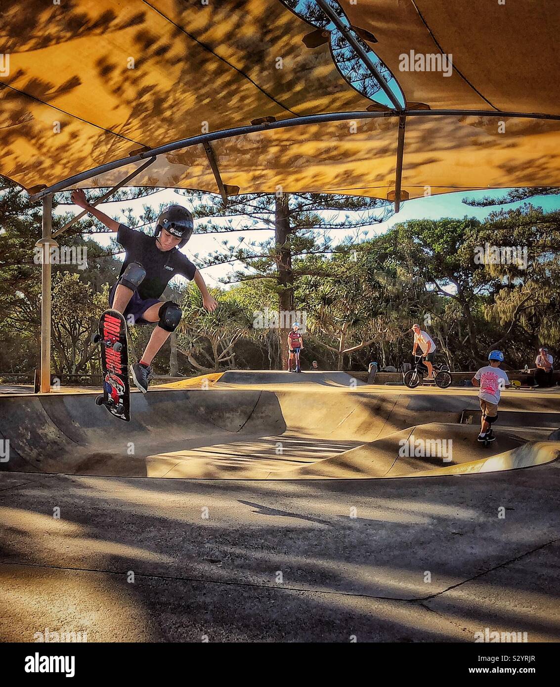 Skateboarding scooter action skatepark Stock Photo - Alamy