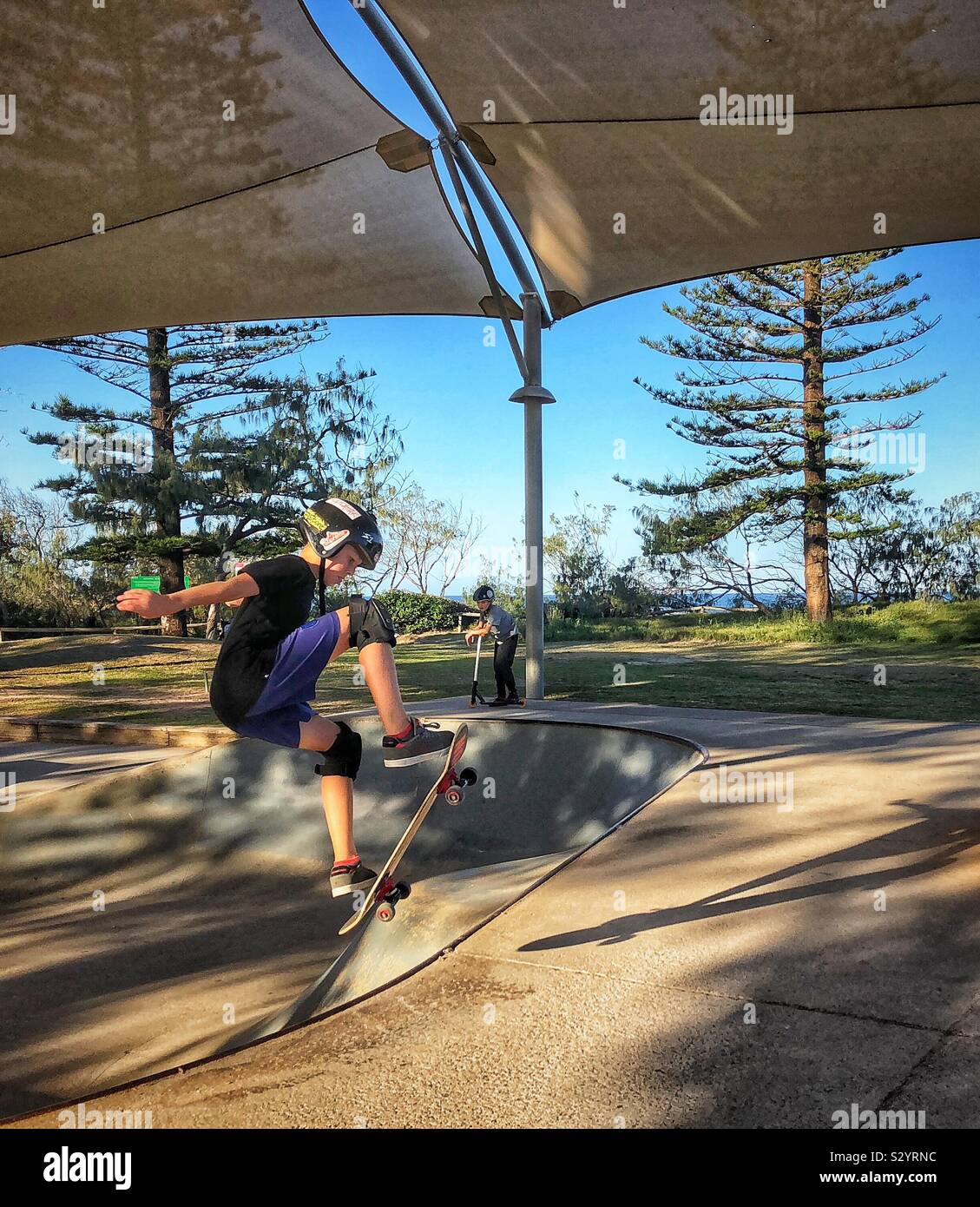 Skateboarding scooter action skatepark Stock Photo - Alamy