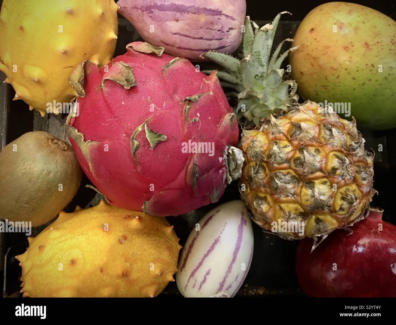 Selection of brightly colored tropical fruit, including pineapple ...