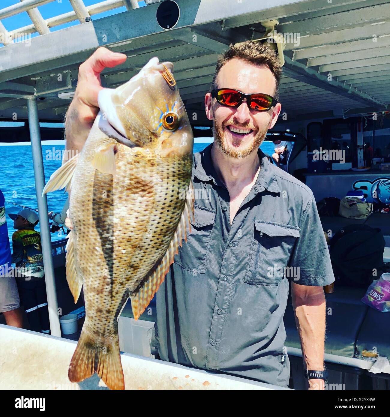 Man with a large fish Stock Photo - Alamy