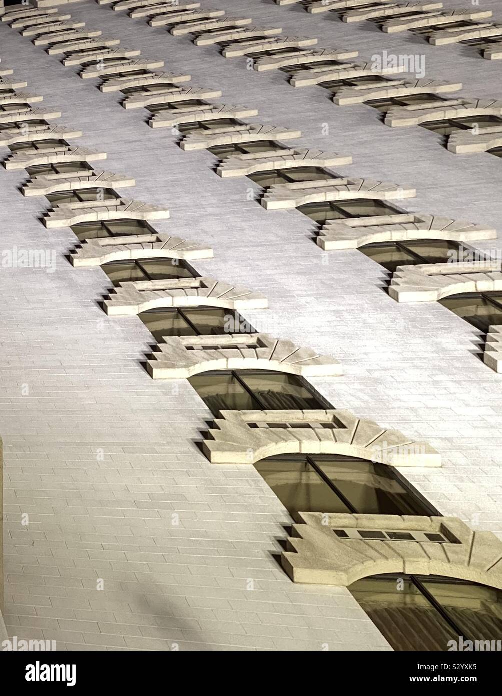 Perspective of a tall side of a wall with decorative boxed windows ...