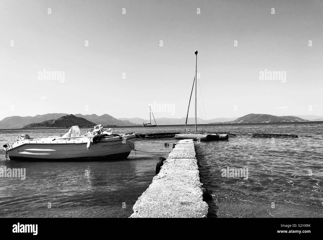 Calm waves and lazy boats Stock Photo - Alamy