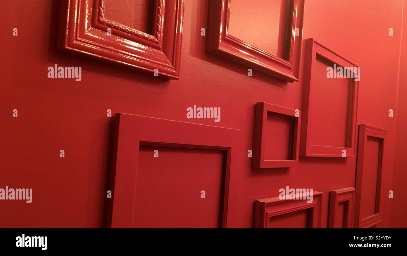 Abstract red picture frames create pattern on red wall Stock Photo - Alamy