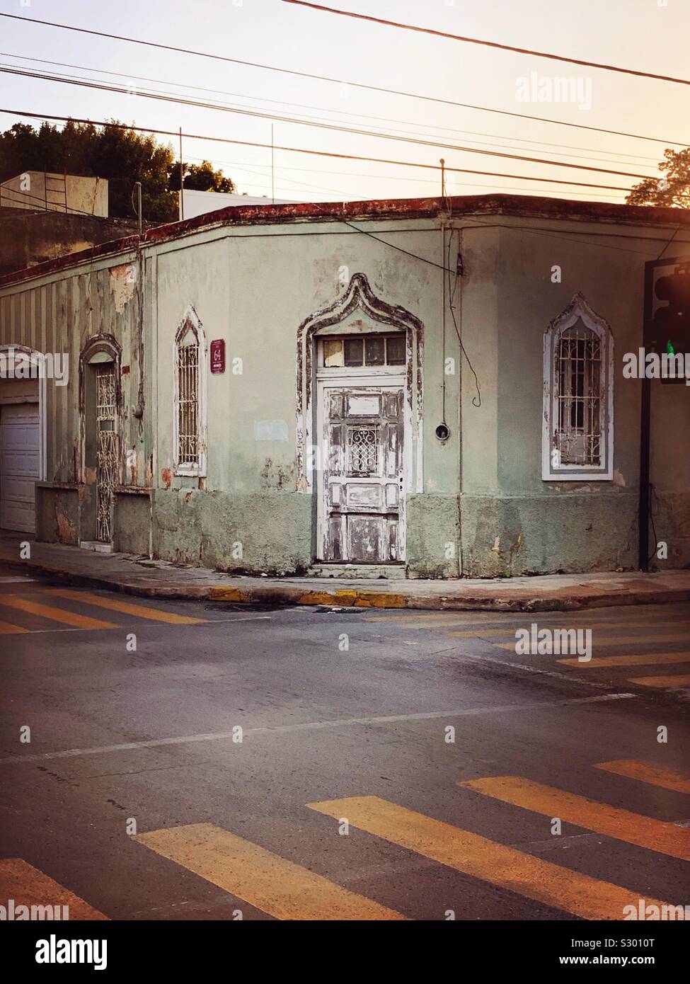 An angled corner building shows signs of age along with elegant details ...