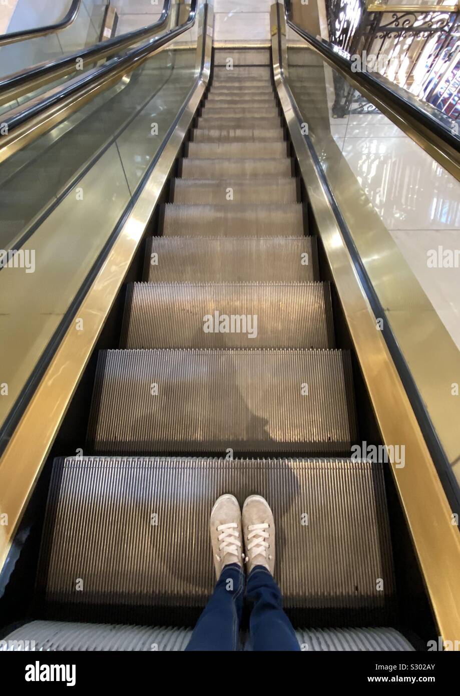 Perspective going down a very long escalator Stock Photo - Alamy