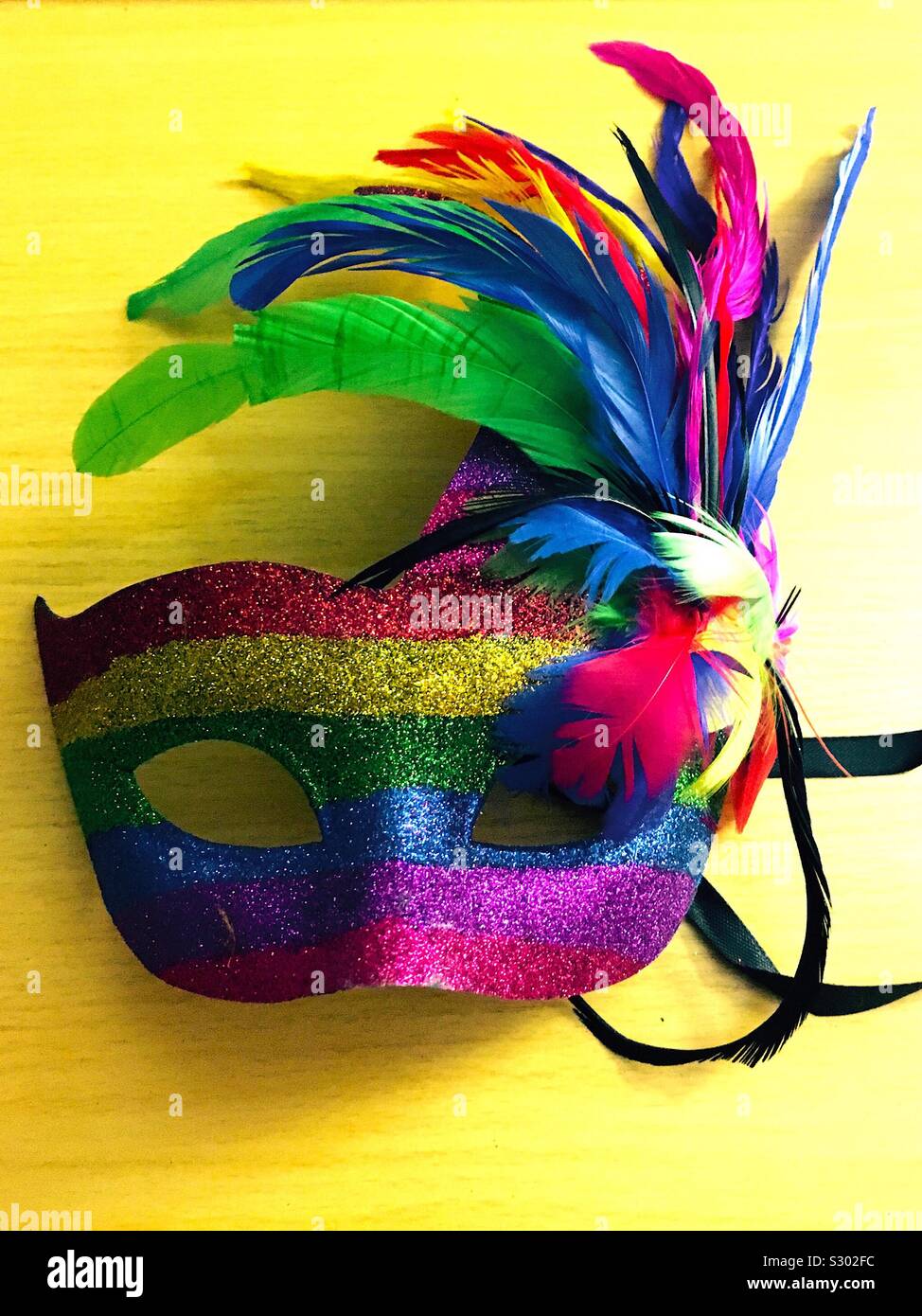 Rainbow feather mask Stock Photo - Alamy