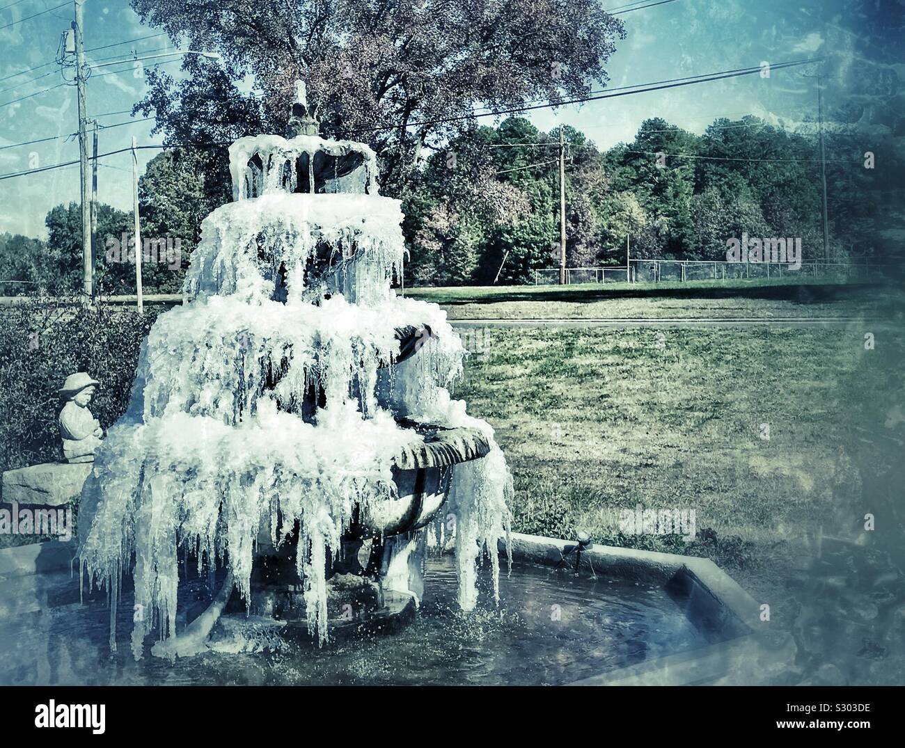 Grunge photo of fountain frozen over during overnight cold snap ...
