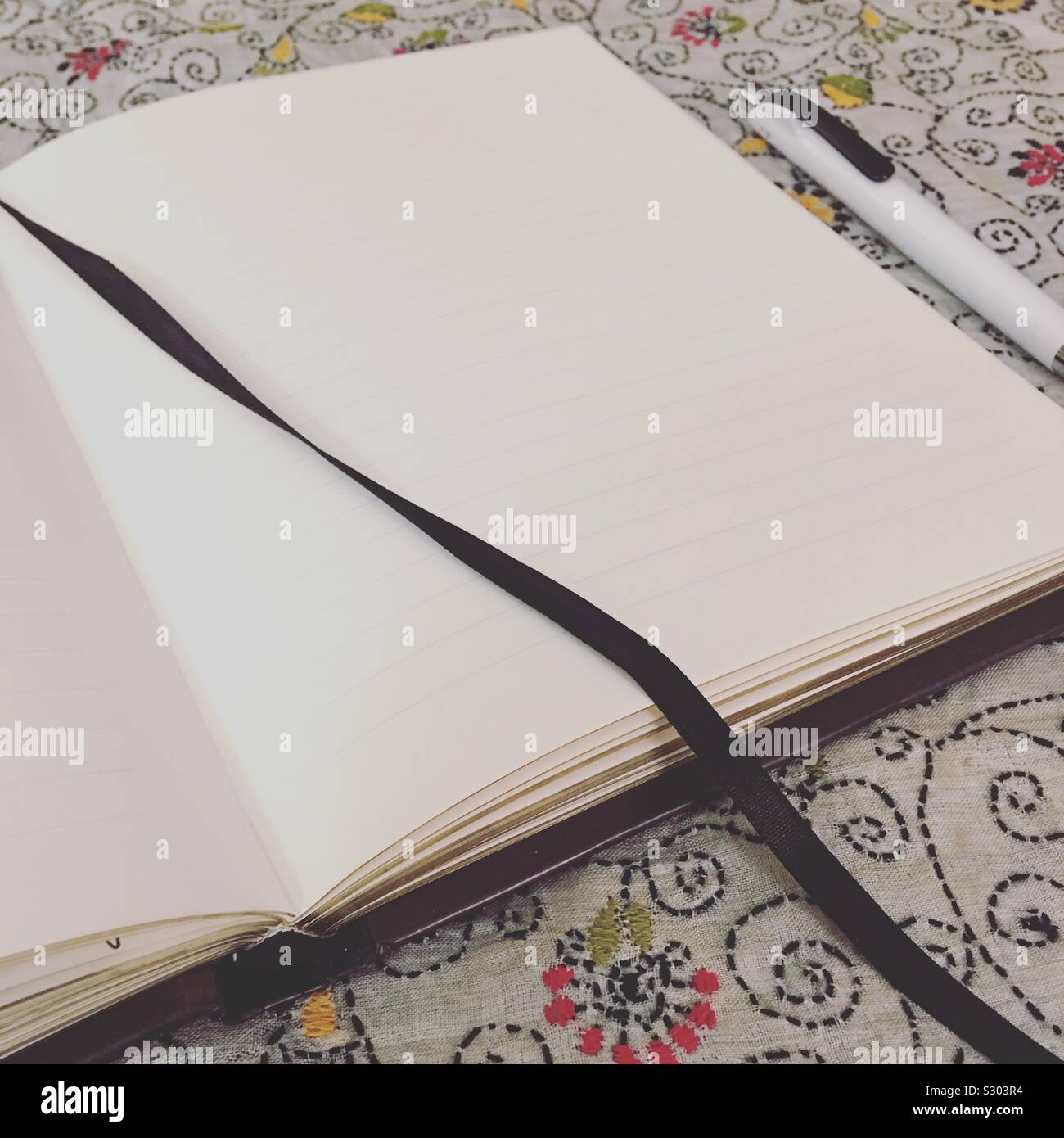 Open notebook with pen with creative background Stock Photo - Alamy