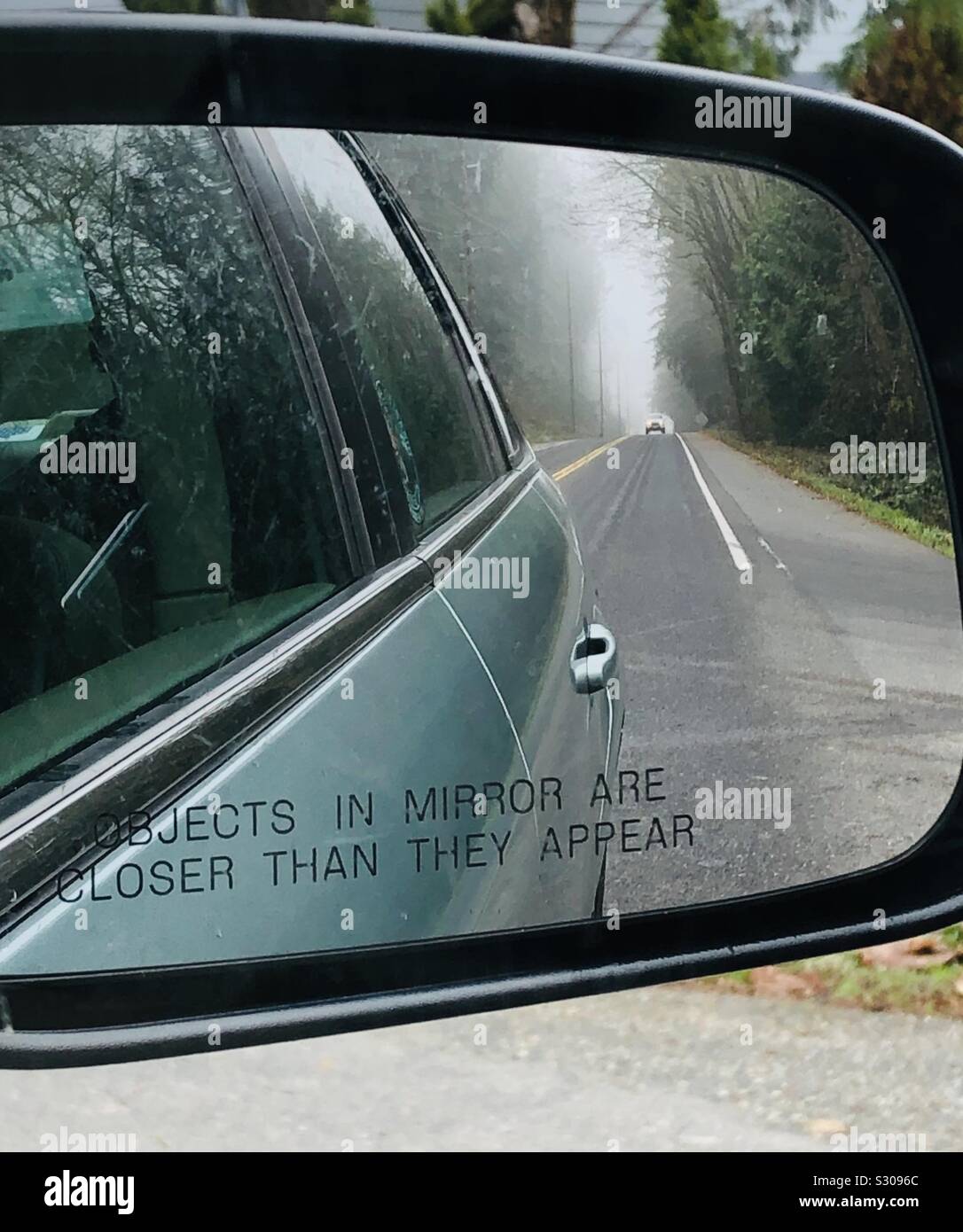 Rear view mirror looking back into fog Stock Photo - Alamy