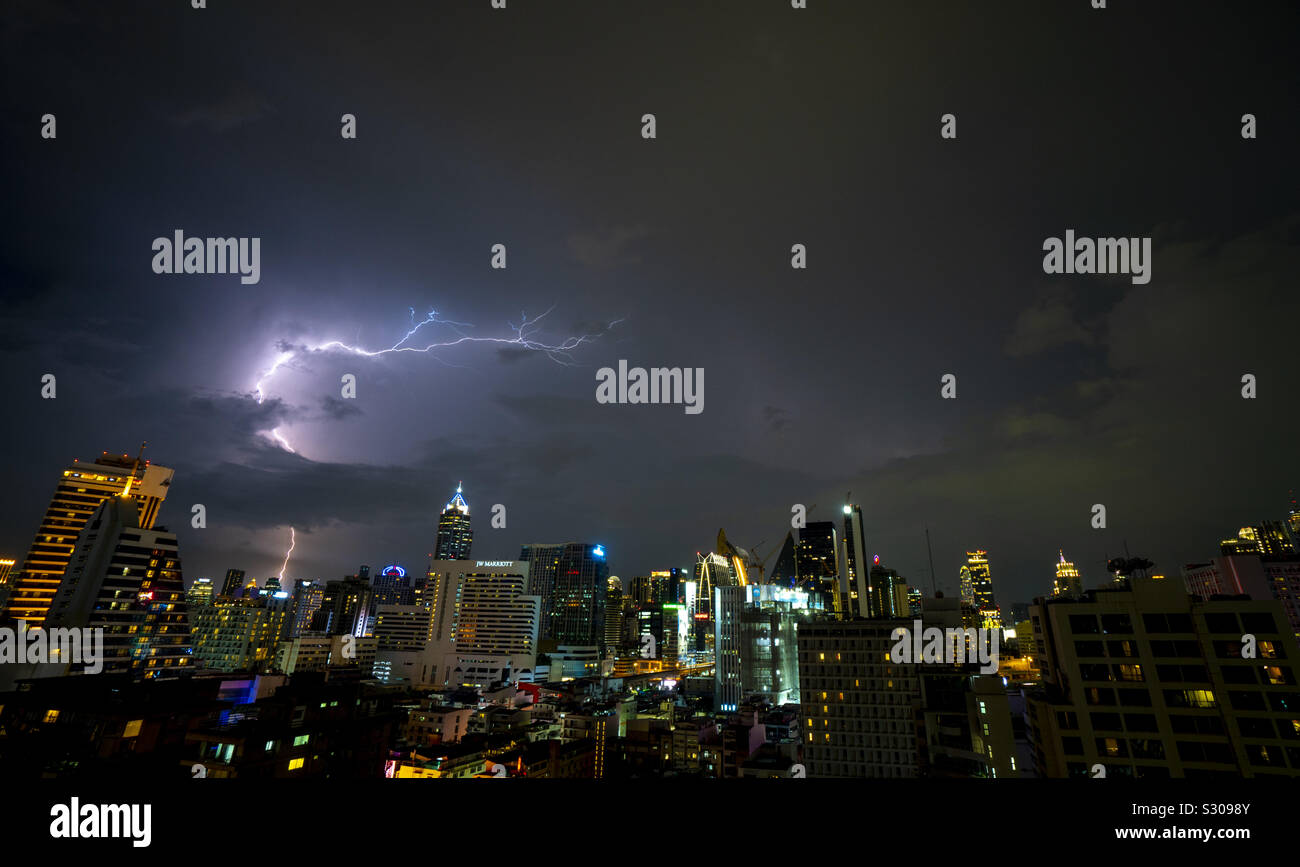 Lightning flash across city night sky Stock Photo - Alamy