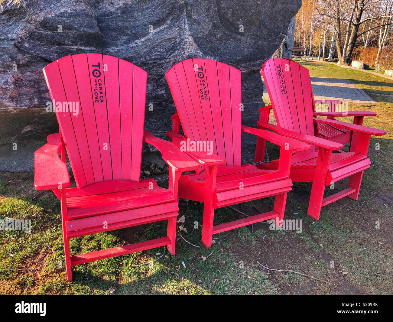 Three red chairs in a row Stock Photo - Alamy