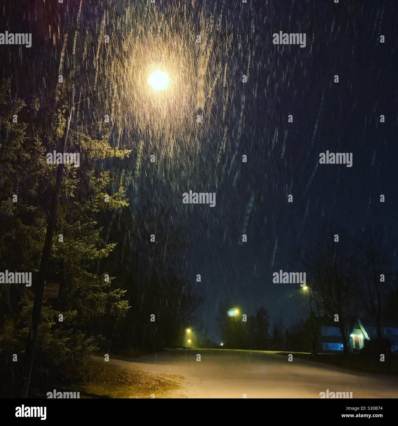 Snowy street at night, lit by street lights Stock Photo - Alamy