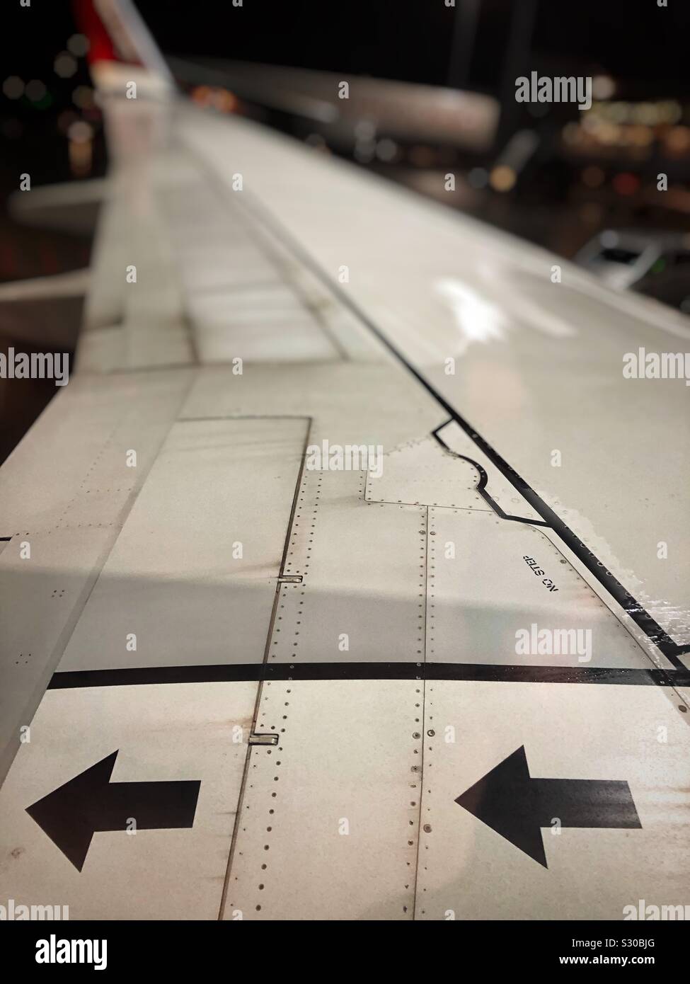 Walk this way: Decal with arrows pointing backwards on wing of a Boeing ...