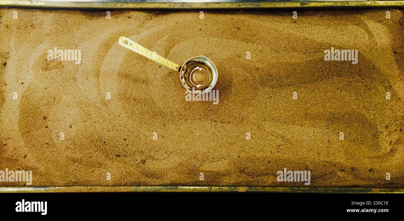 Traditional Greek coffee brewed in the hot sand Stock Photo - Alamy