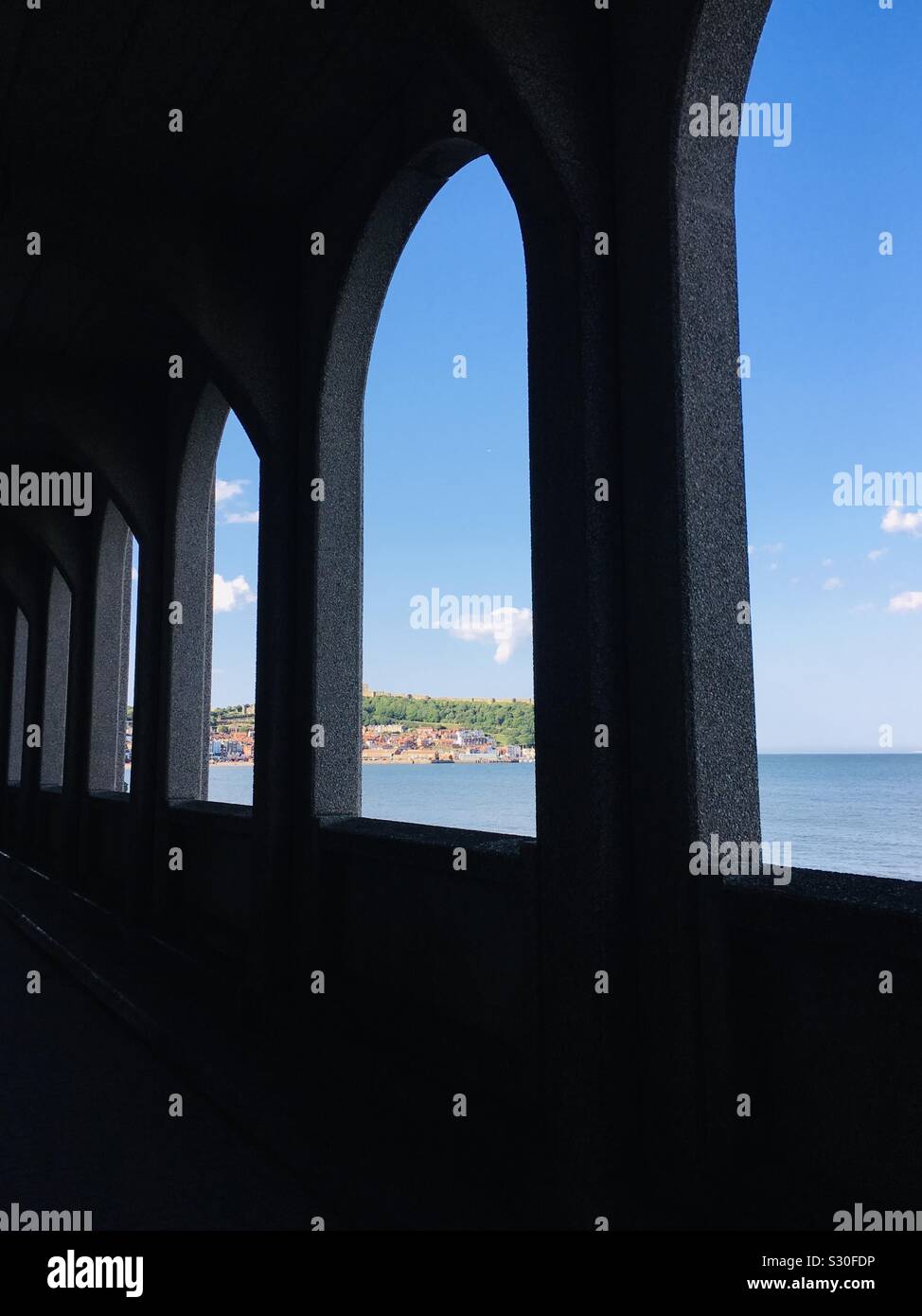 View of Scarborough, Yorkshire through building with open style windows ...