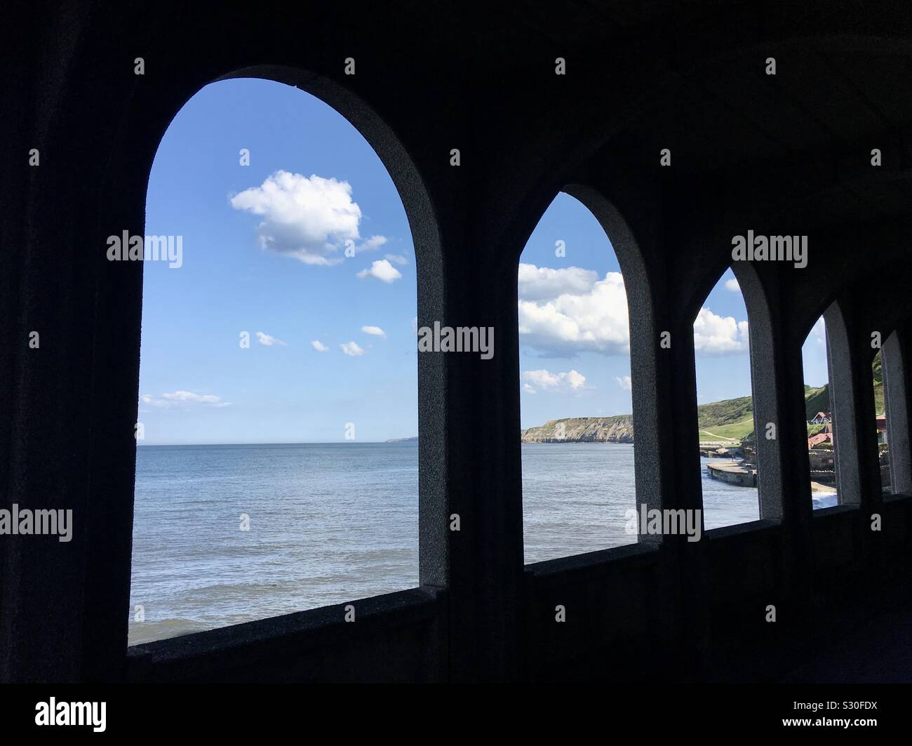 View of Scarborough, Yorkshire through building with open style windows ...