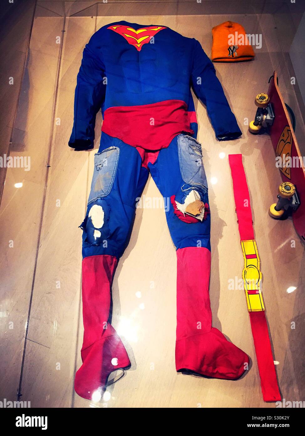 A ripped and torn superman outfit in the Member:Pope L exhibit at the ...