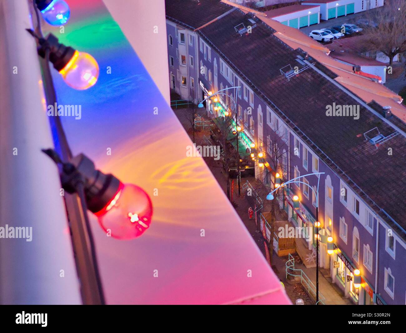 Dusk twilight view from skyscraper 12th floor terrace with colourful ...