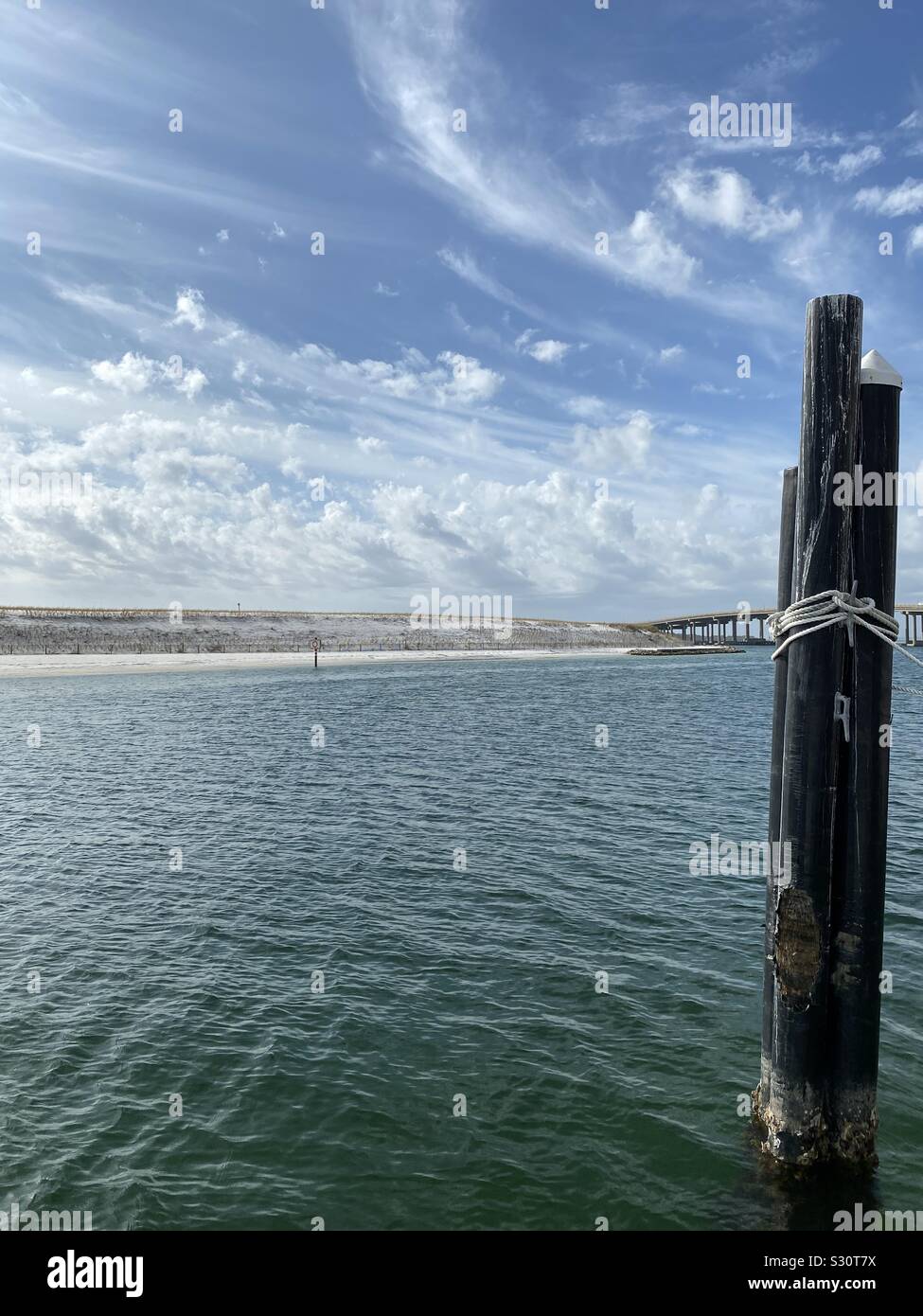 View of harbor water with beautiful skies and boat dock pole Stock ...