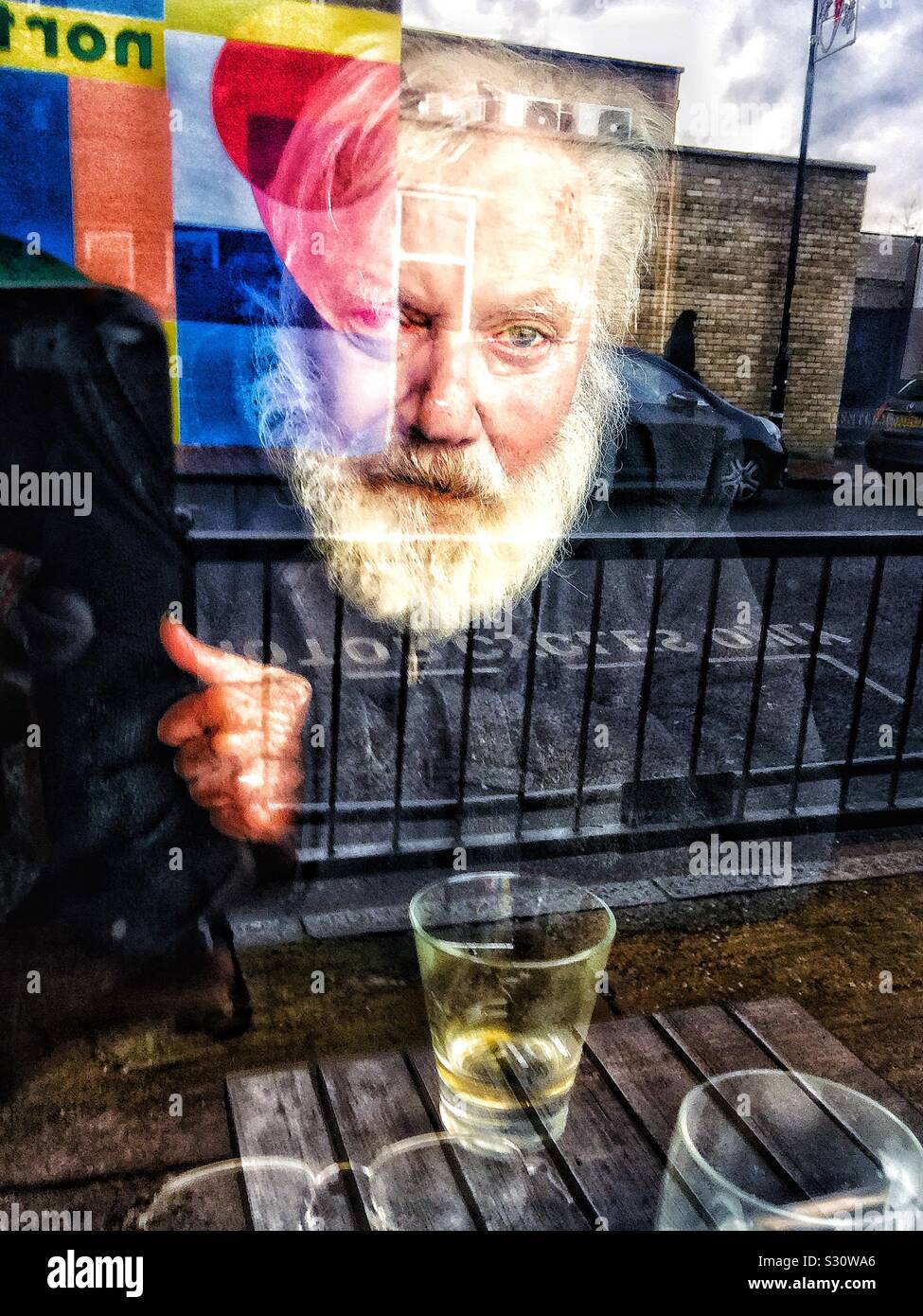 A mature gentleman gazes out of a pub window Stock Photo - Alamy
