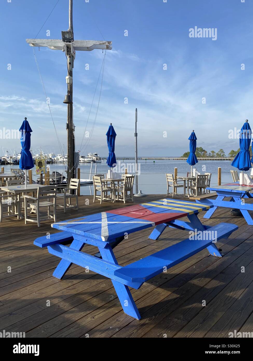 Outdoor eating area with colorful benches at boat marina Stock Photo ...