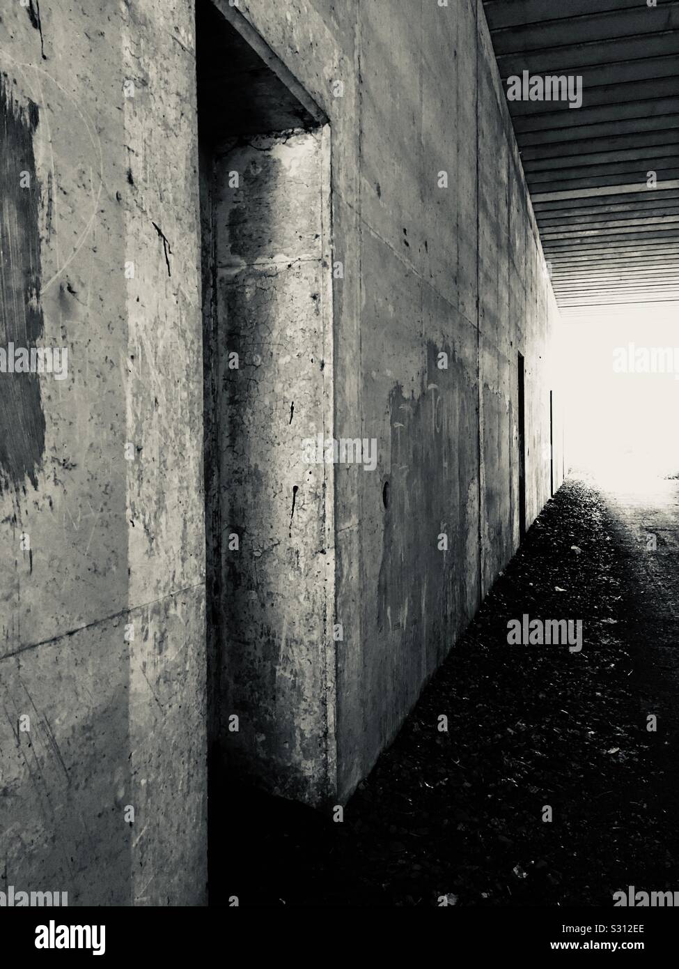 Walkway under a concrete bridge Stock Photo - Alamy
