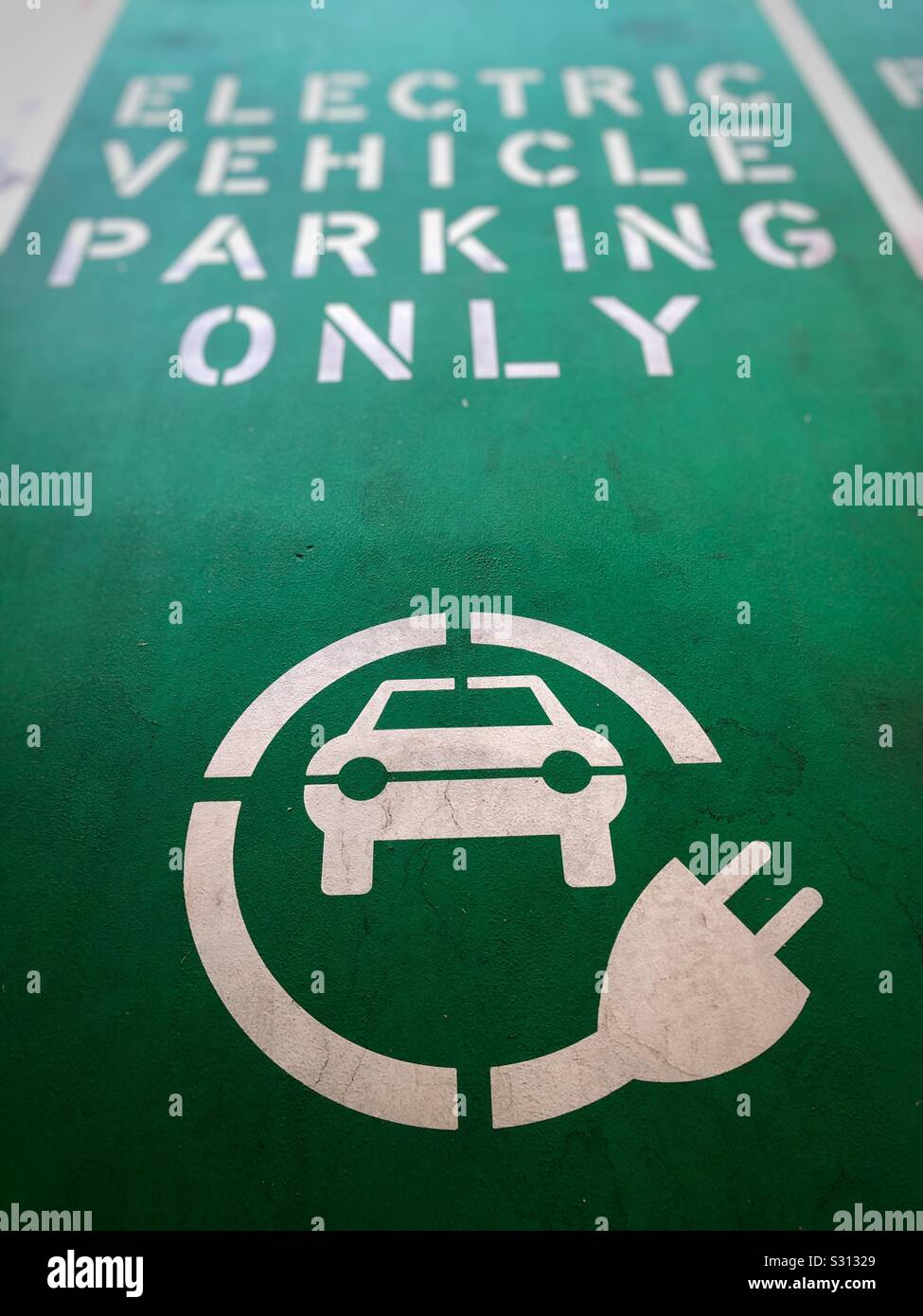 Electric vehicle parking only sign painted on the ground of a parking ...