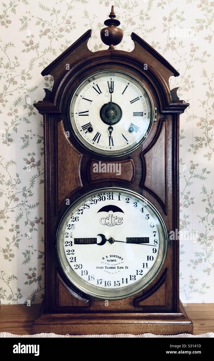 Vintage wooden mechanically wound clock with days of the month dial ...