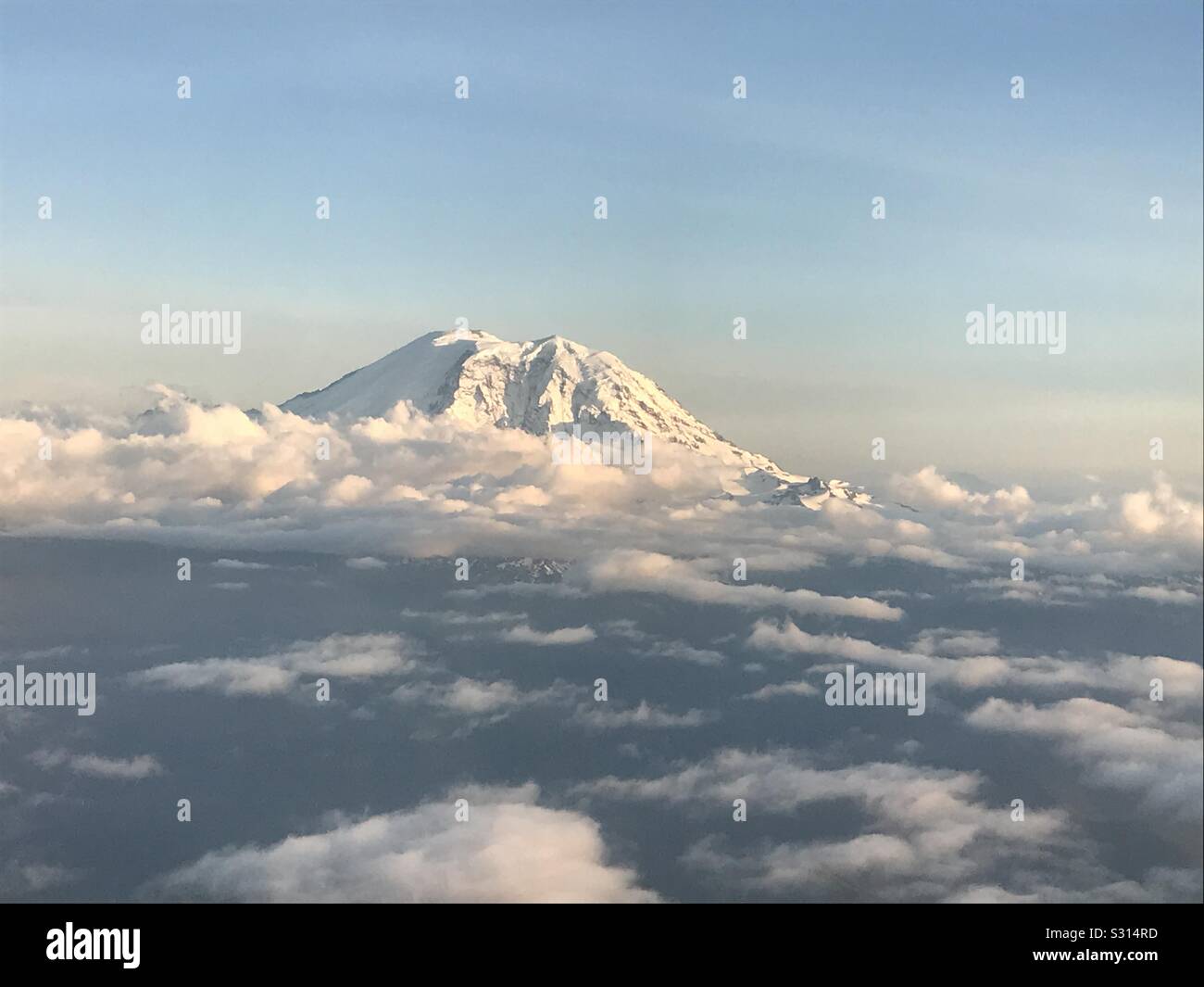 Mt. Rainier and national forest, aerial view, with snow and clouds ...