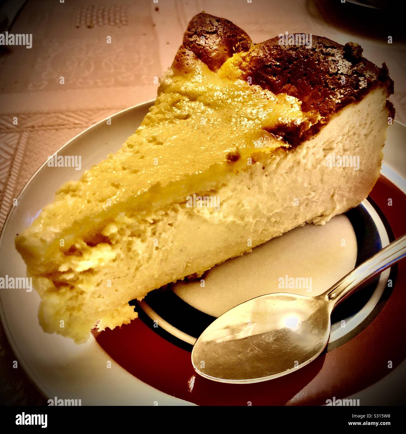 Basque style burnt cheesecake portion on a plate Stock Photo - Alamy