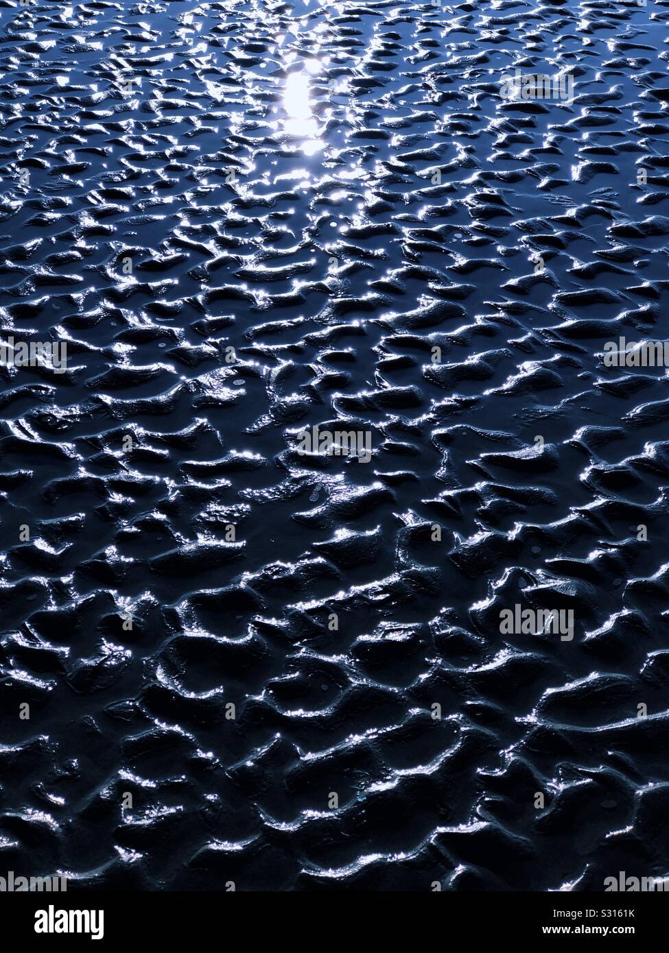 Wet sand with ripples at night Stock Photo - Alamy