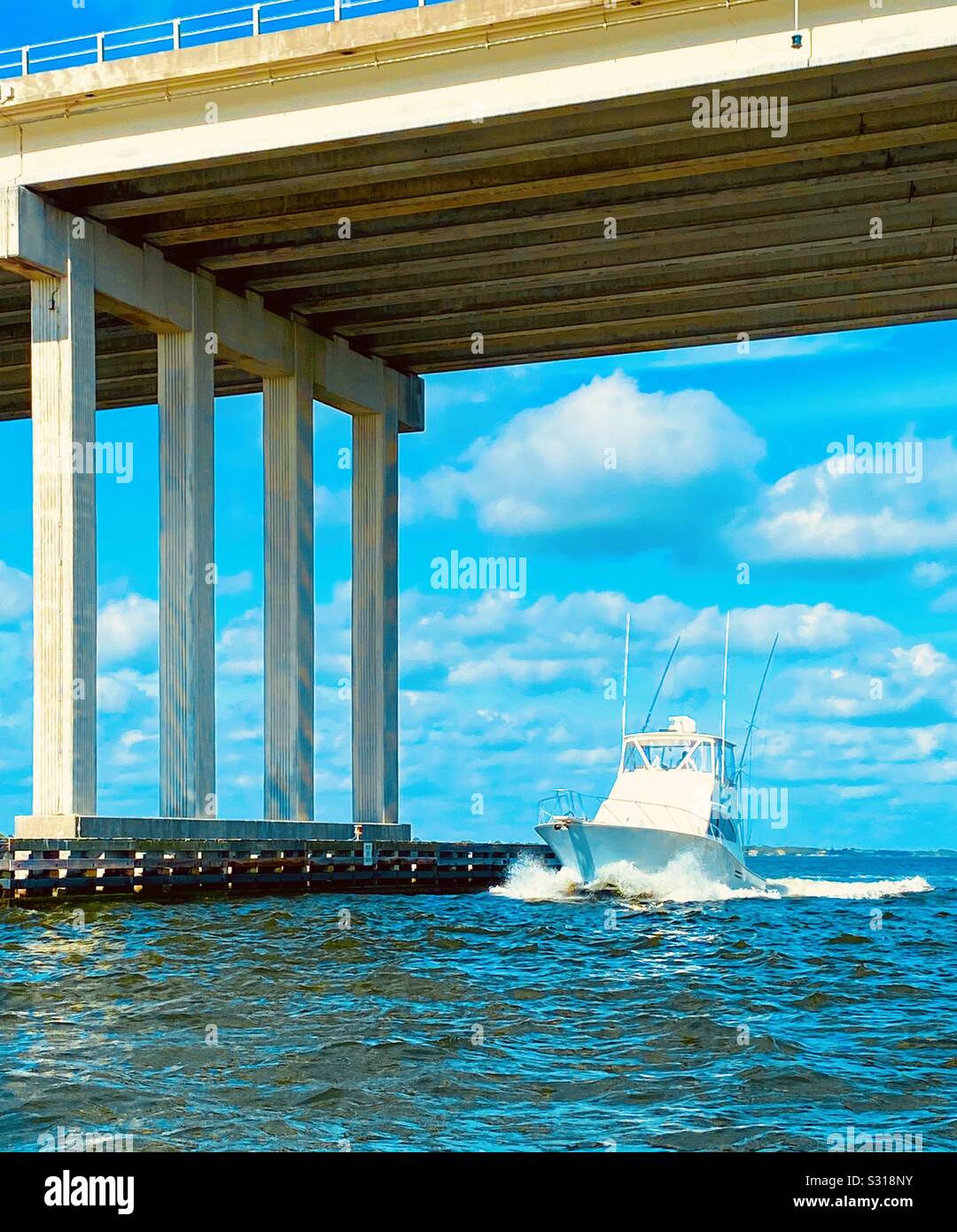 Yacht passing under a bridge Stock Photo - Alamy