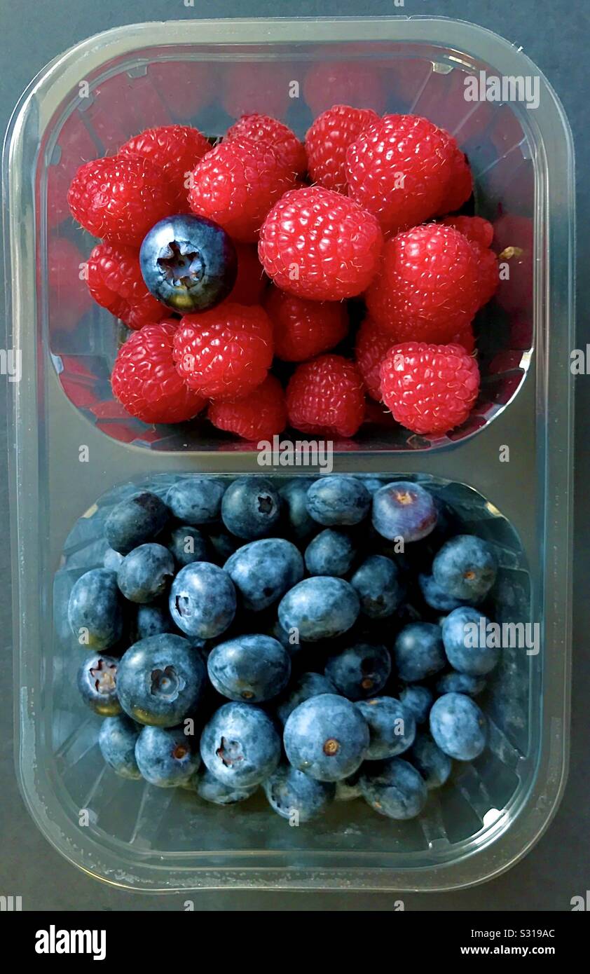 Overhead shot of a punnet of raspberries and blueberries Stock Photo ...
