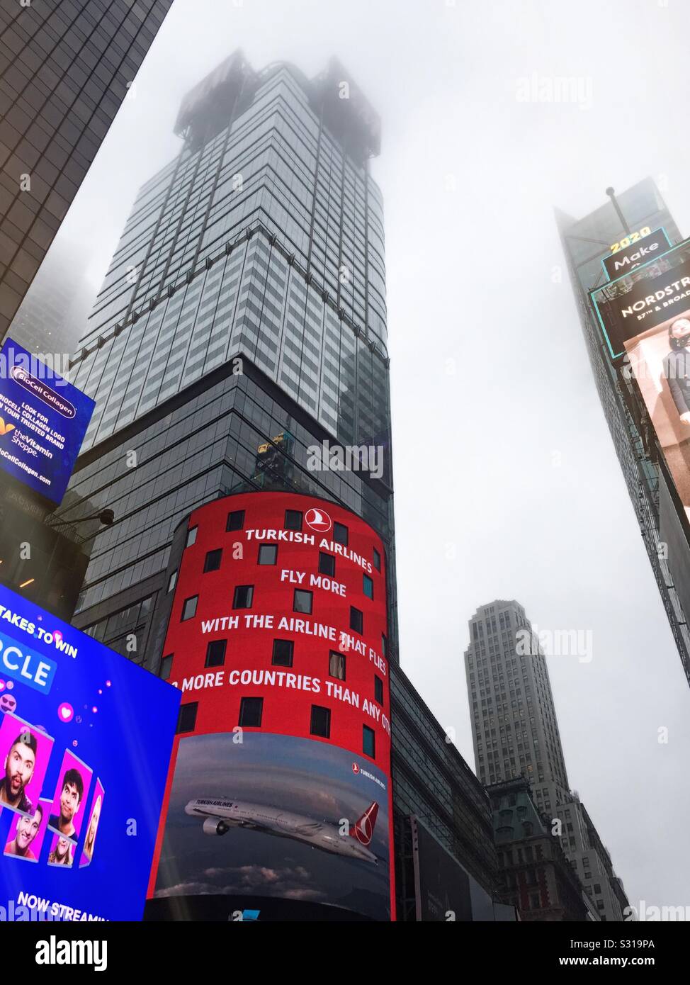 Skyscrapers and electronic billboards in Times Square on a foggy ...