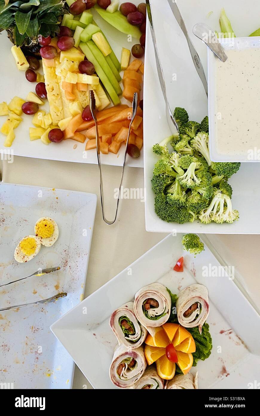 Picked over buffet table Stock Photo - Alamy