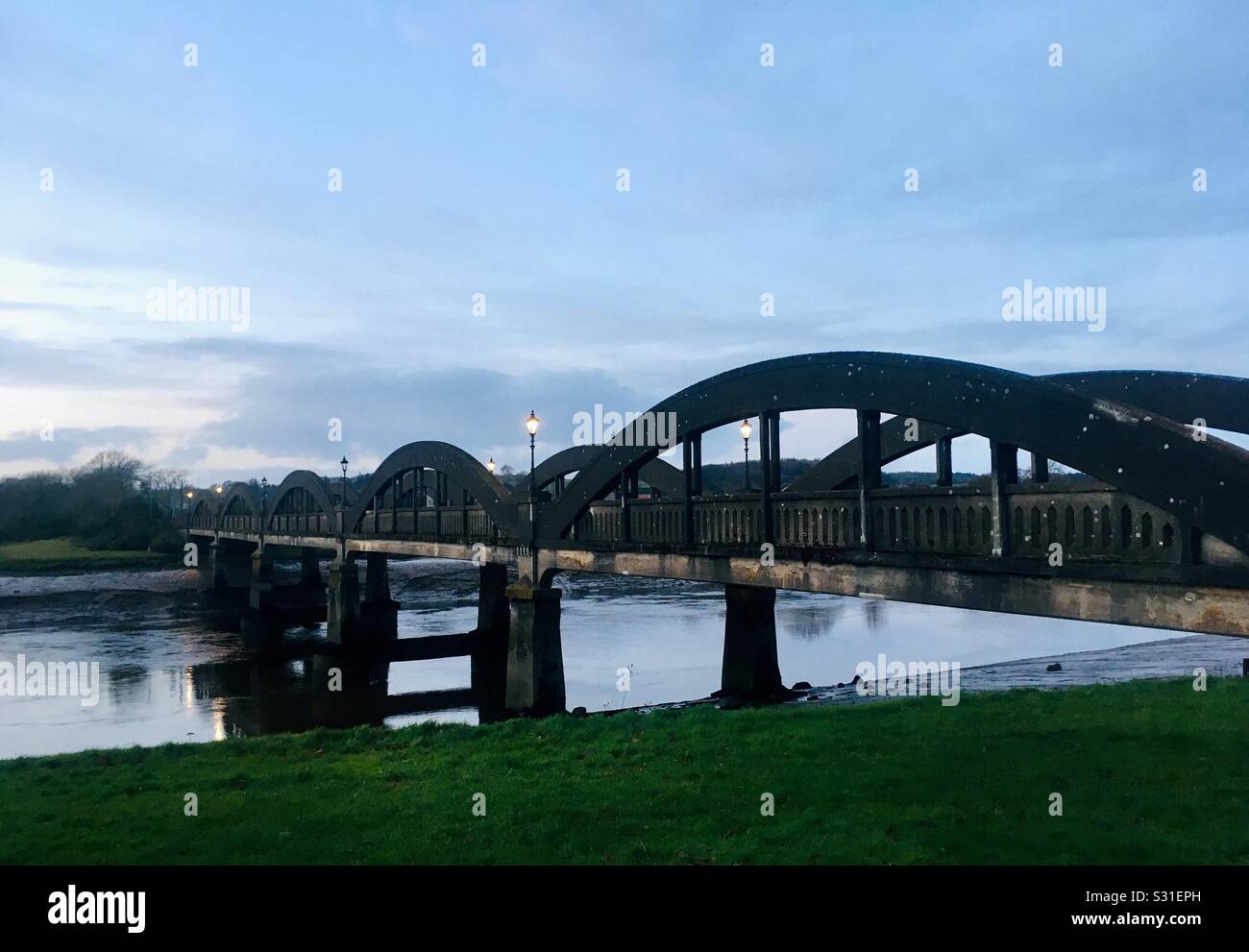 Kirkcudbright Bridge over the River Dee At dusk. A concrete bridge with ...