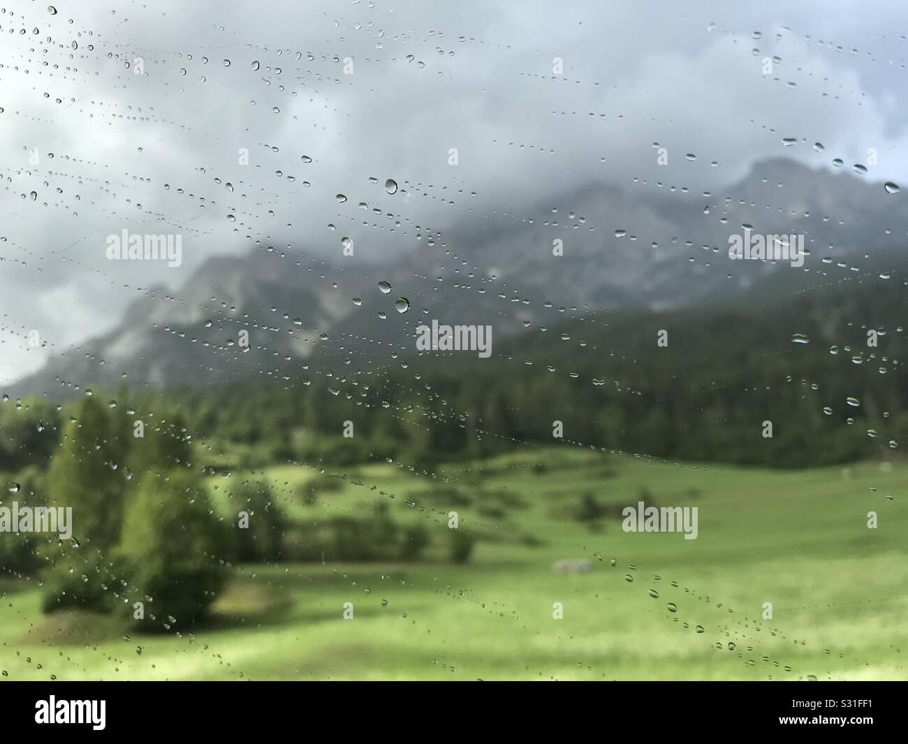 Mountains in Rainy day behind the window Stock Photo - Alamy