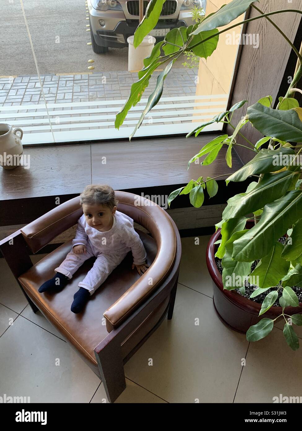 A kid waiting for a table in a restaurant Stock Photo - Alamy