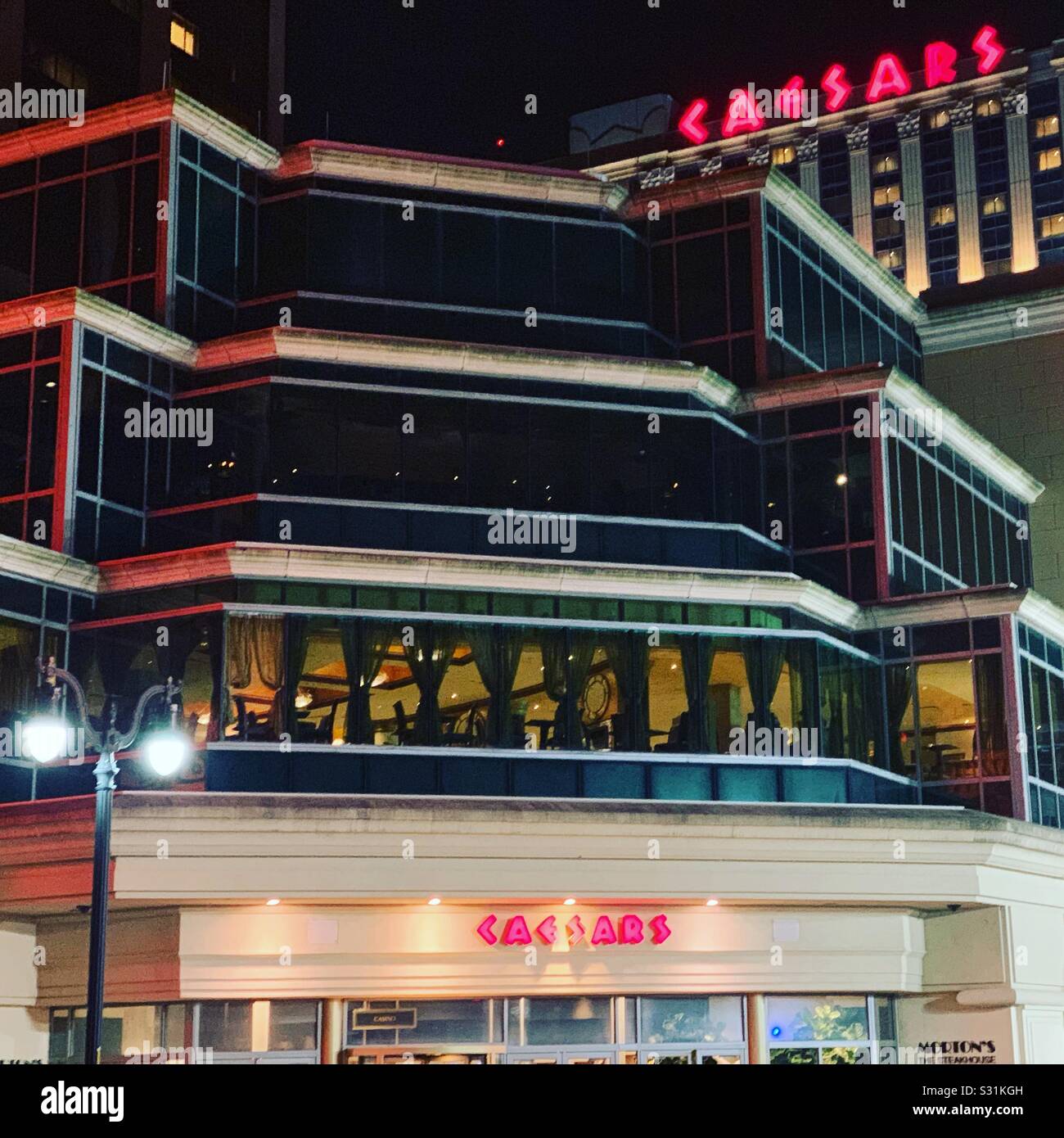 A view of Caesars Atlantic City from the Boardwalk at night. Atlantic ...