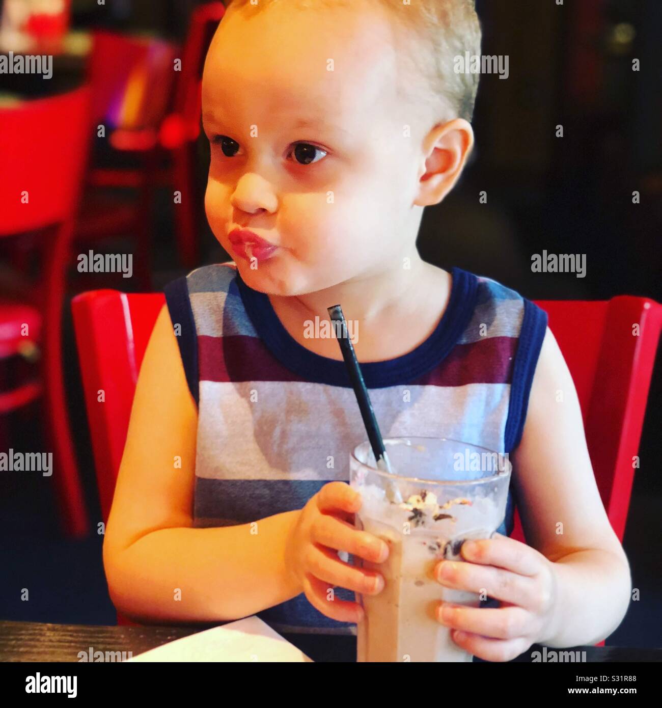 Baby and his milkshake Stock Photo - Alamy