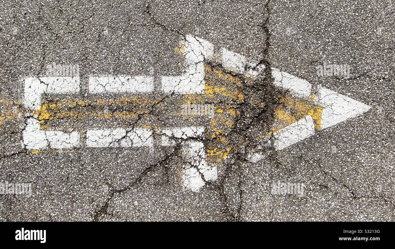 Weathered arrow on concrete Stock Photo - Alamy