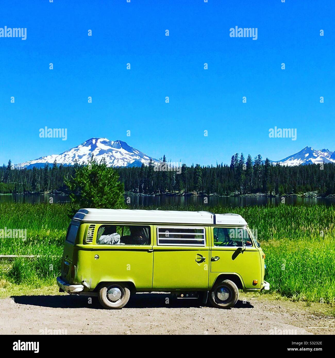 VW Bus campervan with snow covered mountains and lake landscape Stock ...