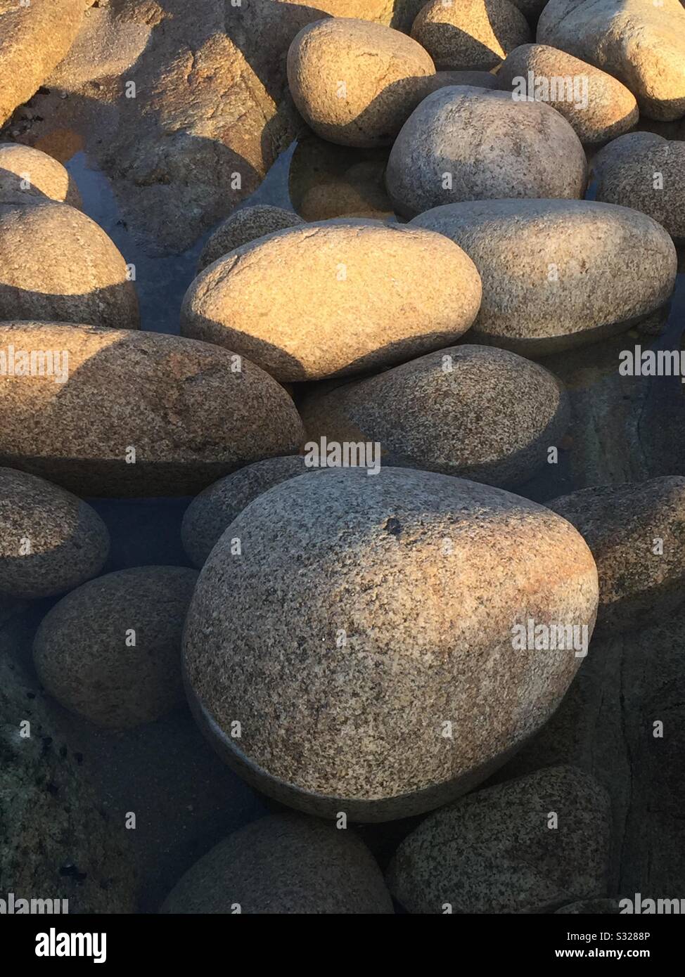 Rock boulders in the sea Stock Photo - Alamy