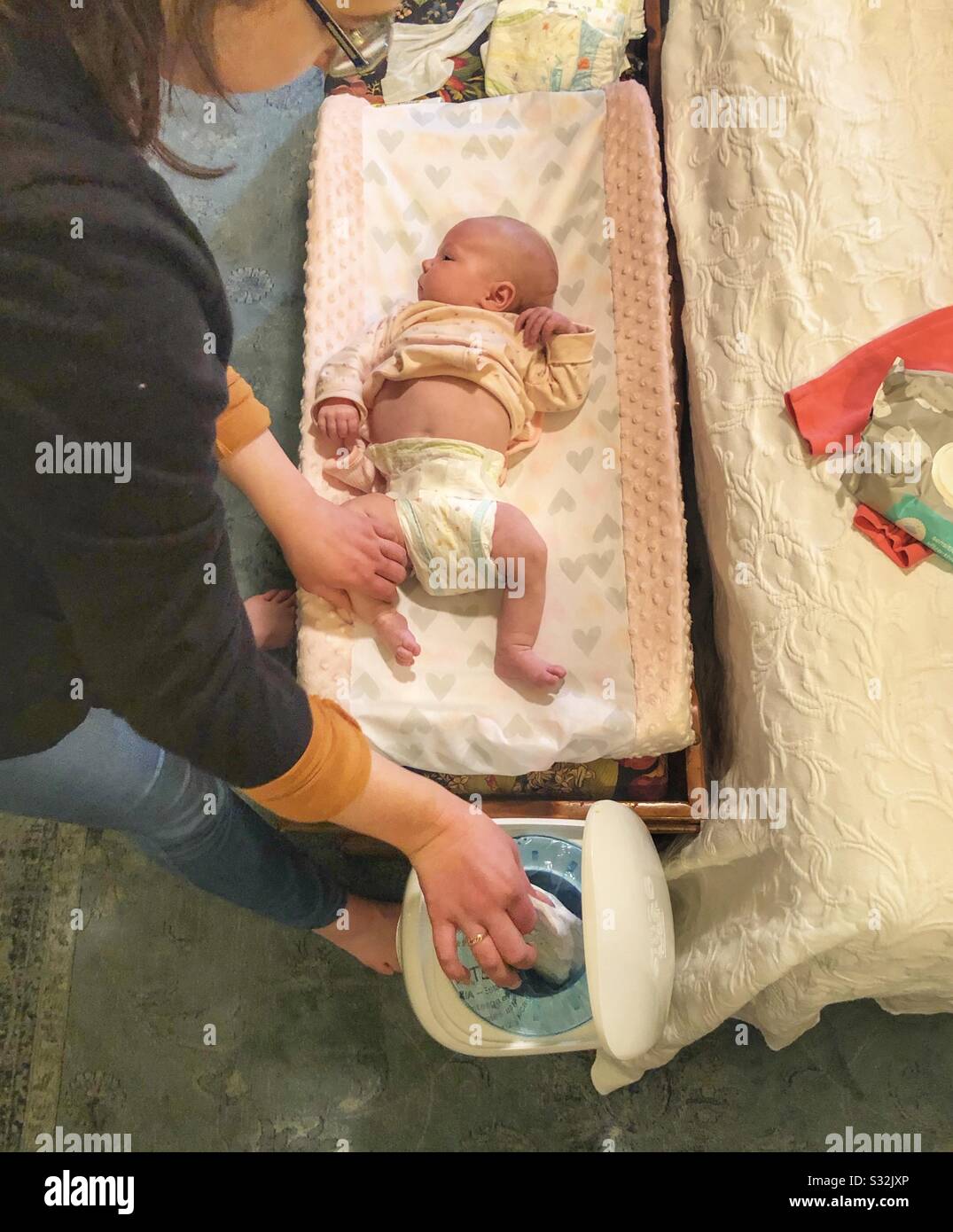 Mom changing baby hi-res stock photography and images - Alamy